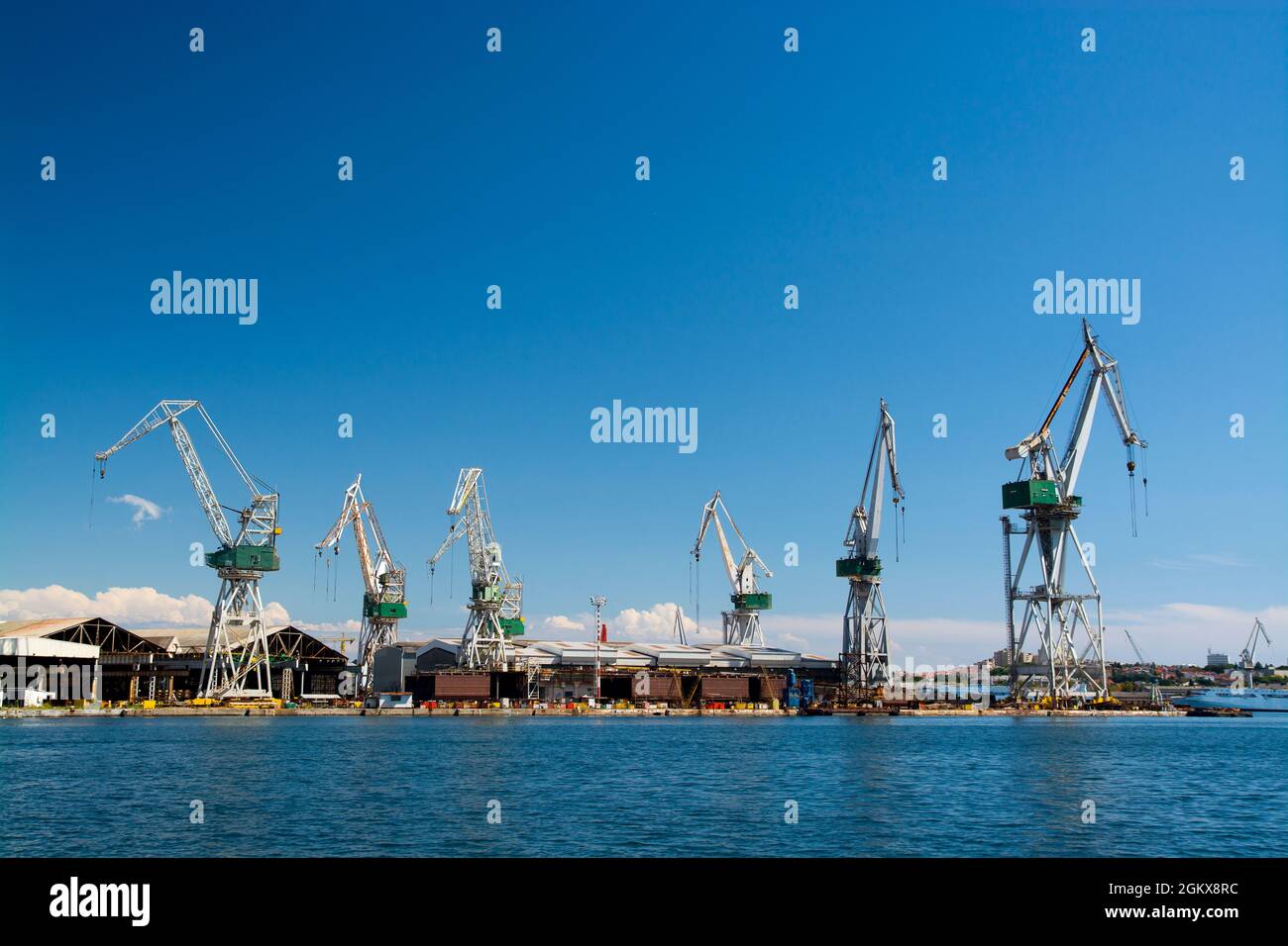 Industrial cranes in docks of Pula port, Istria, Croatia Stock Photo ...