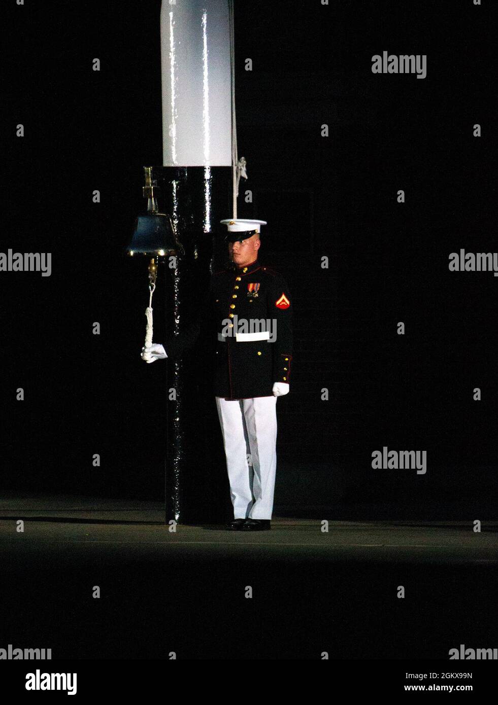 A Barracks Marine strikes the bell signaling the beginning of the ...
