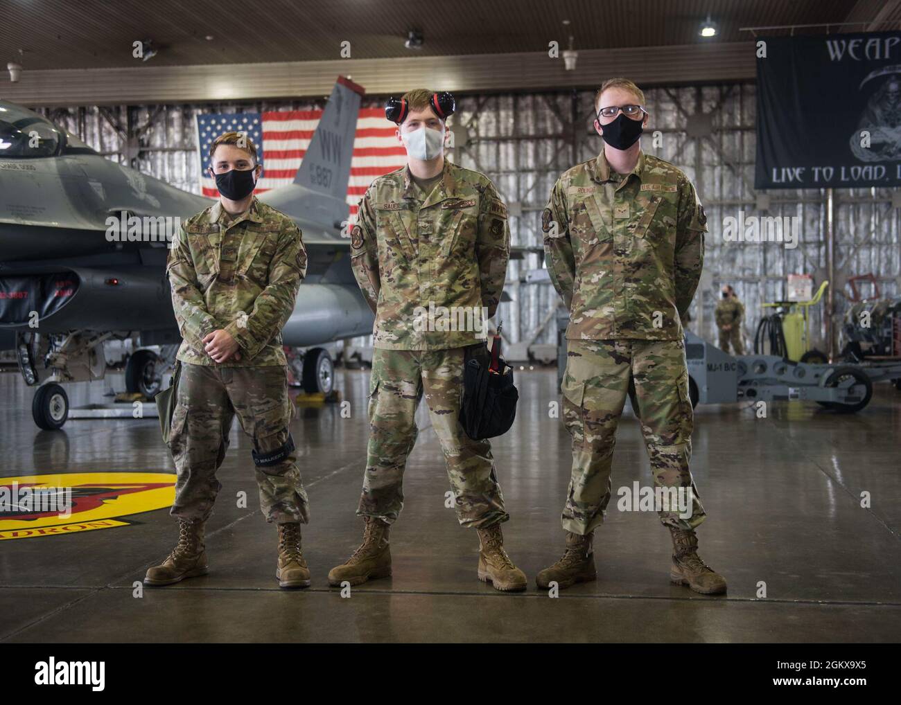 U.S. Air Force Staff Sgt. David Botterill (left), a weapons load team ...