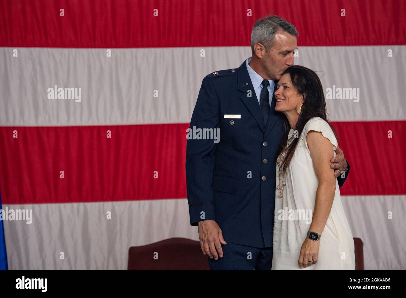 U.S. Air Force Col. Ryan Haden kisses his wife Gwen on the head during ...