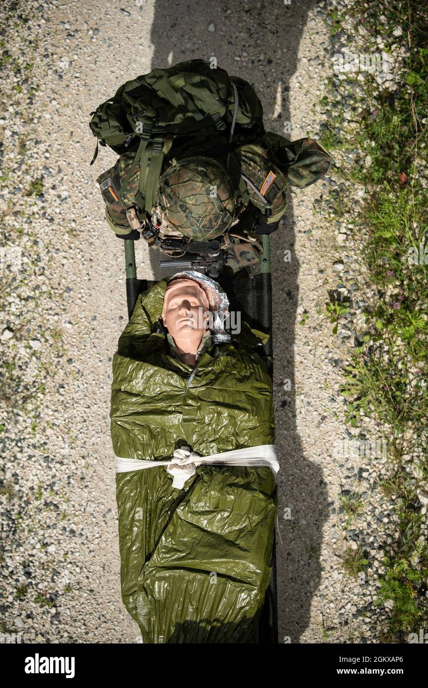 German soldiers use a stretcher to move a simulated casualty to the ...