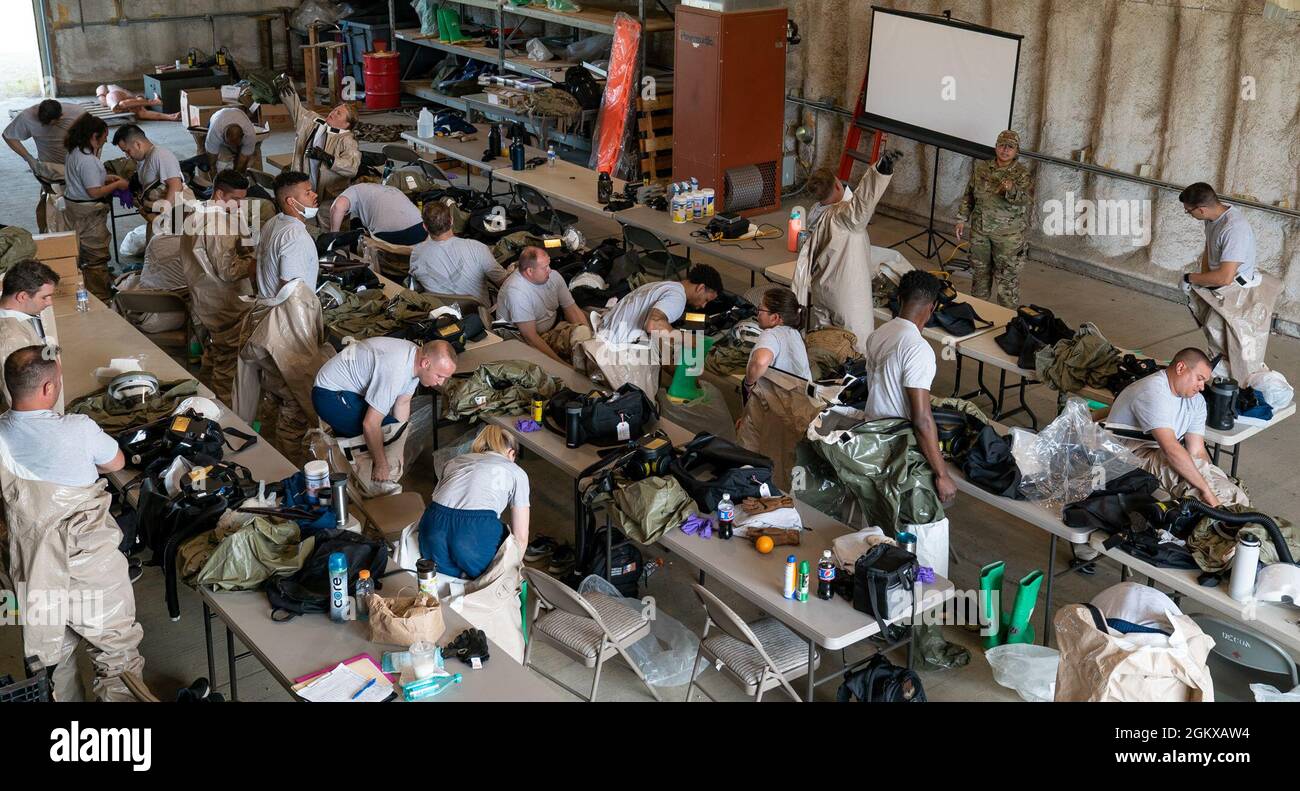 U.S. Airmen don decontamination gear as they begin a training exercise ...
