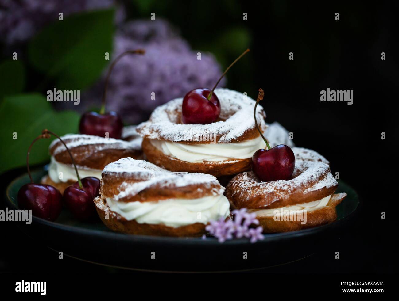 Cream puff rings (choux pastry) decorated with fresh cherry Stock Photo ...