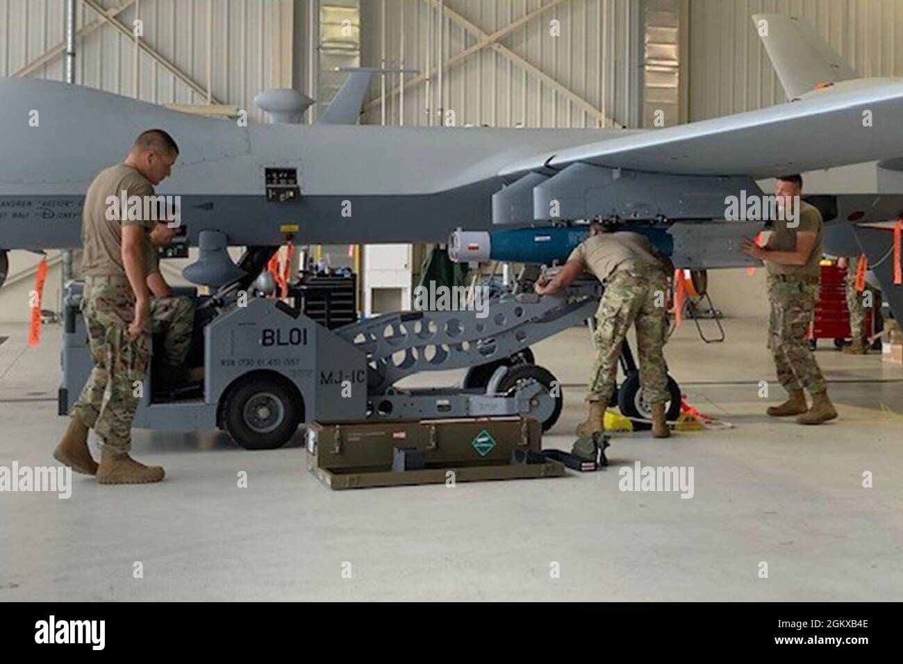 Members of the 147th Attack Wing load munitions on an MQ-9 Reaper at ...