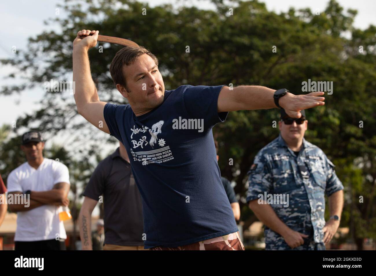Military personnel take turns throwing a boomerang as part of the ...