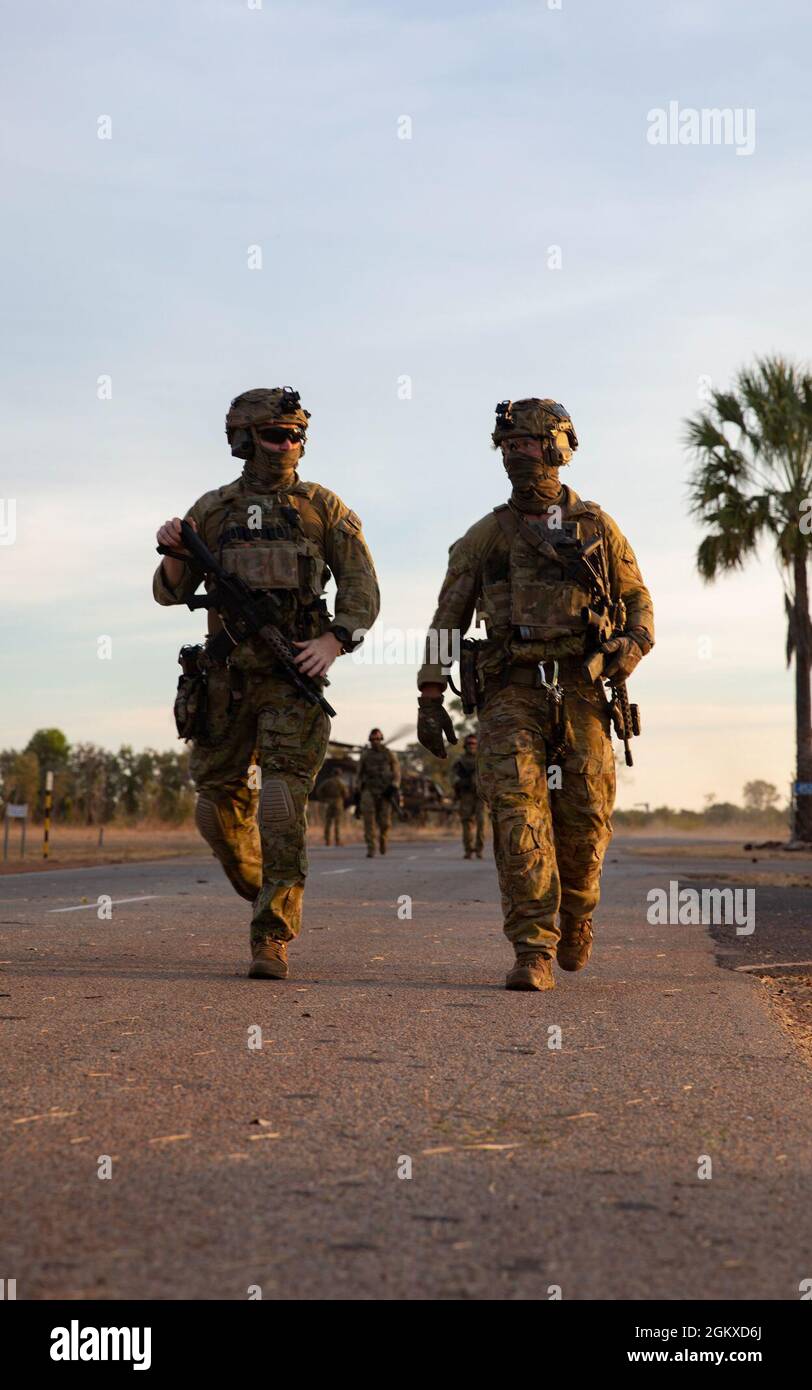 Australian Defence Force military personnel walk toward their ...