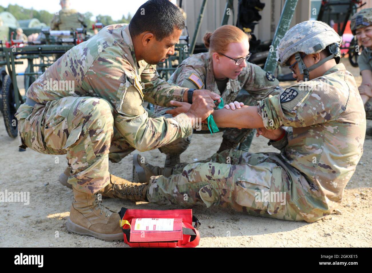 Combat medics attached to the 399th Field Hospital assist a live role ...