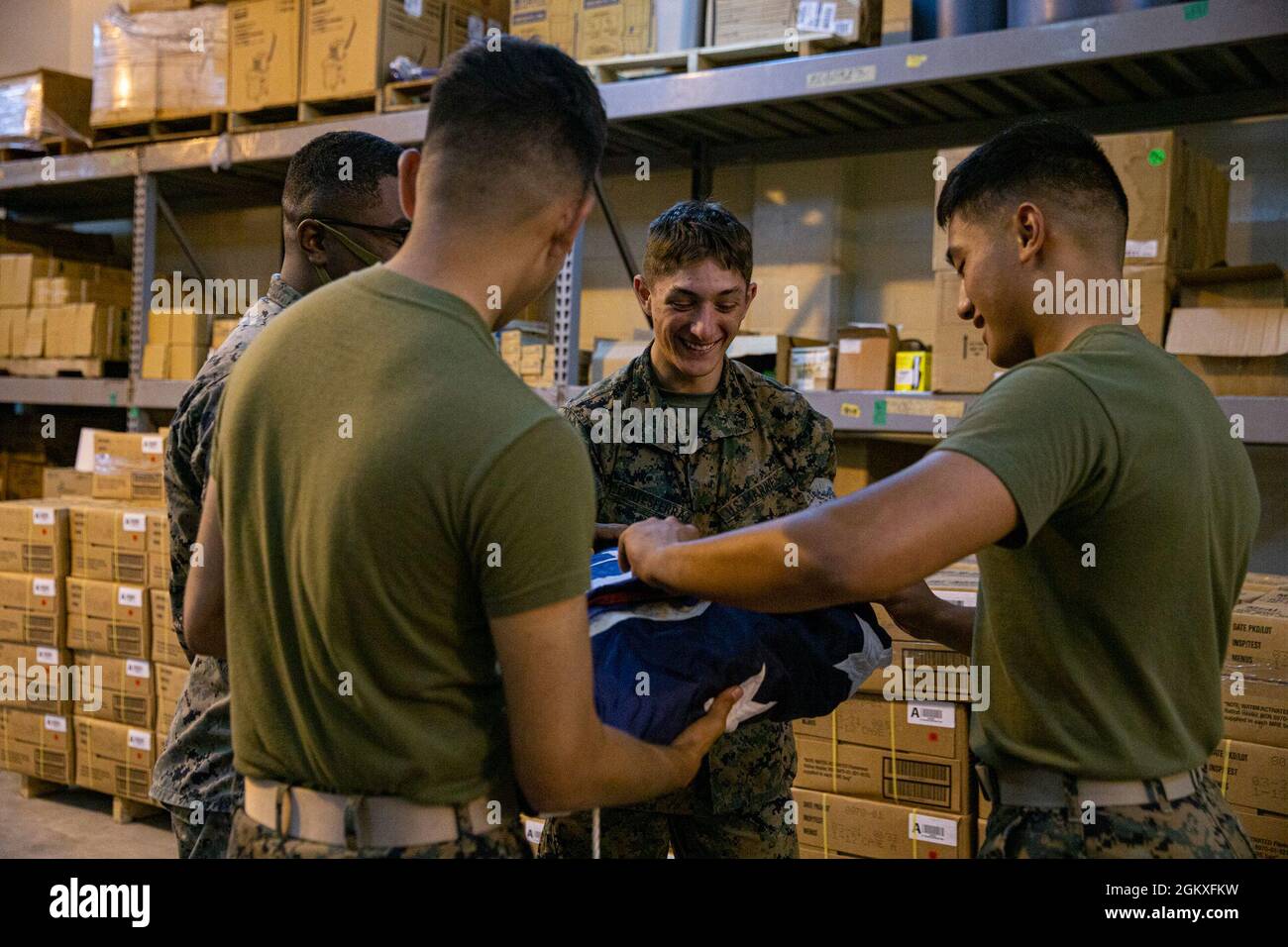 U.S. Marines with Camp Foster Camp Services, fold the U.S. flag on Camp ...