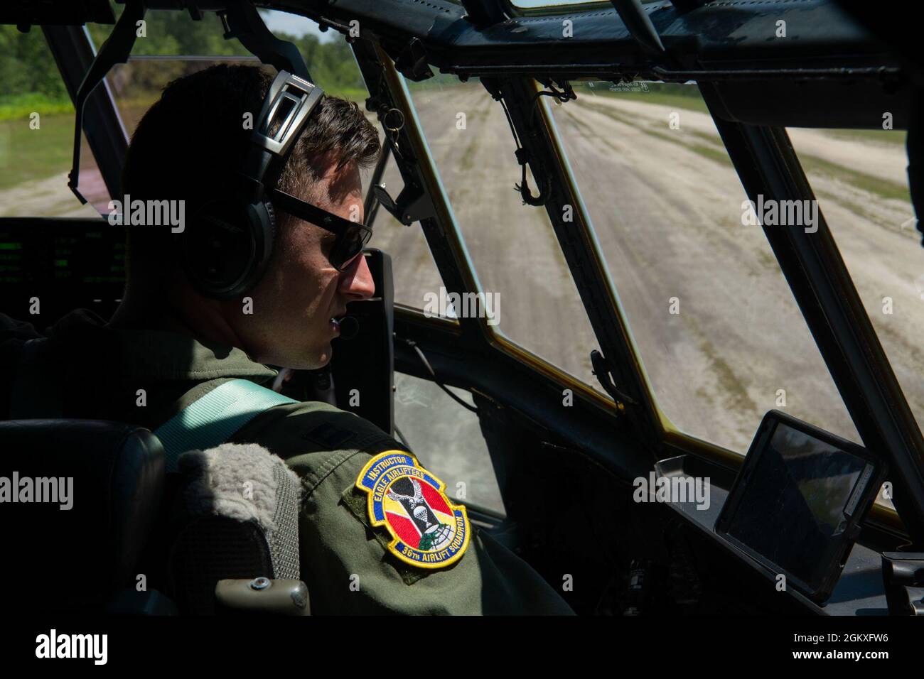 U.S. Air Force pilot, Capt. Garrett Mazachek looks out of the window as ...
