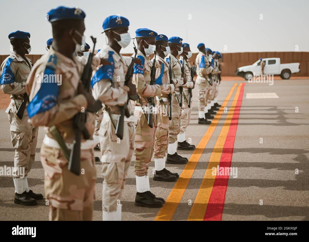 Service members from the Nigerien Armed Forces (FAN) stand in formation ...