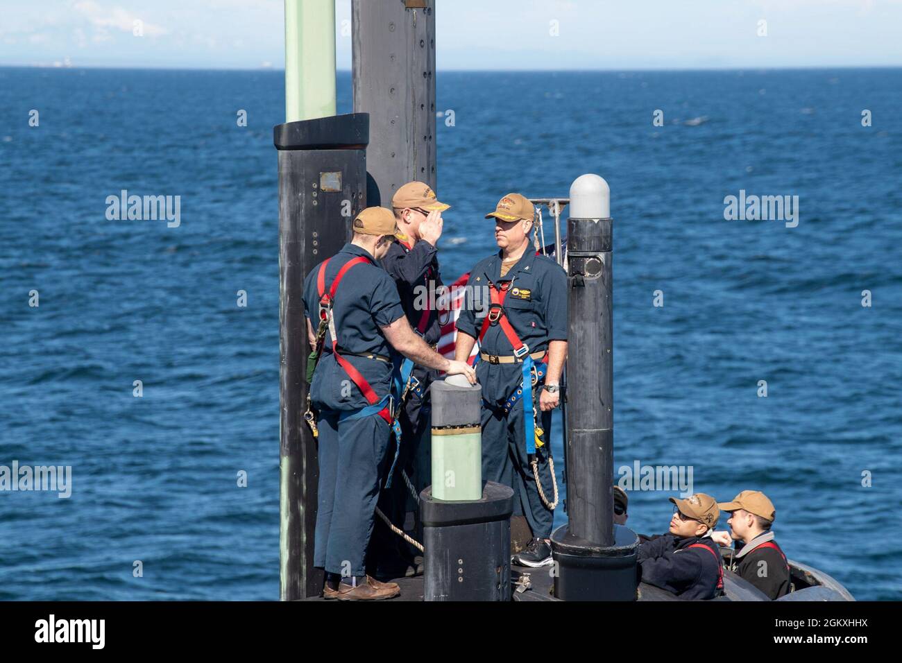 SILVERDALE, Wash. - Cmdr. Jason Glab salutes Capt. Charles McLenithan ...