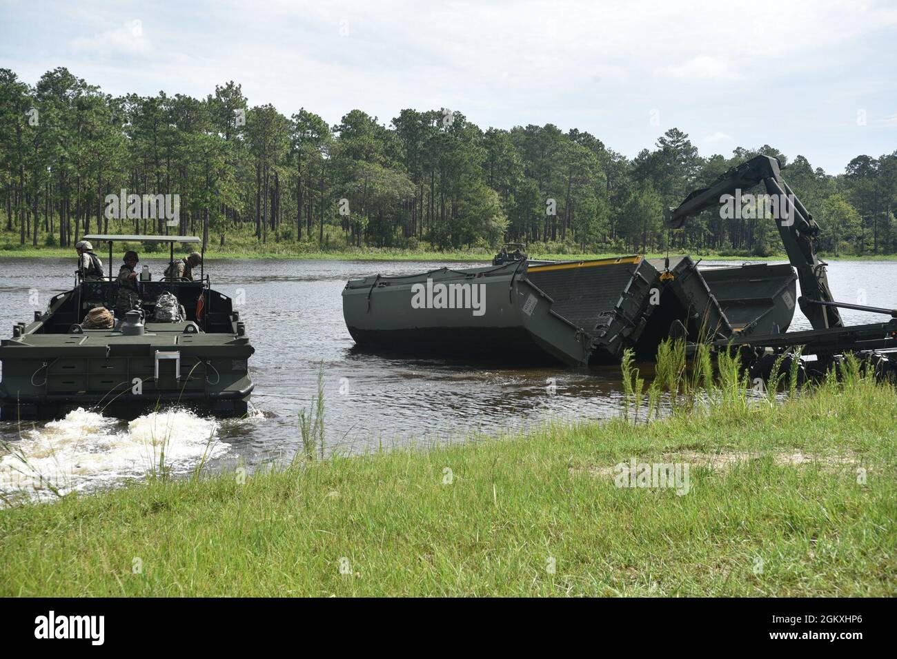 926th Engineer Brigade Soldiers guide collapsible raft into the water ...