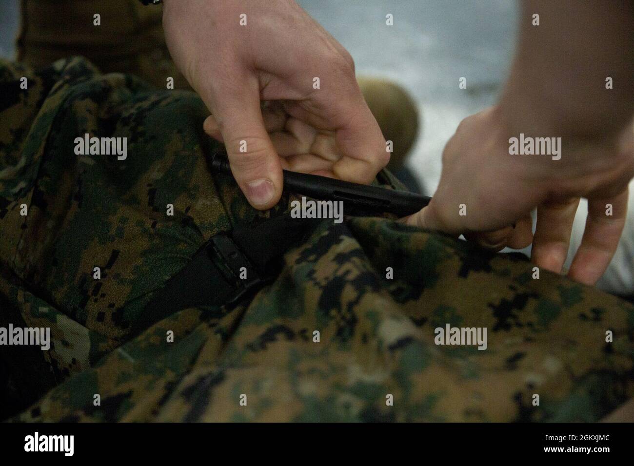 A U.S. Marine with Battalion Landing Team 3/5, 31st Marine Expeditionary Unit (MEU), applies a ...