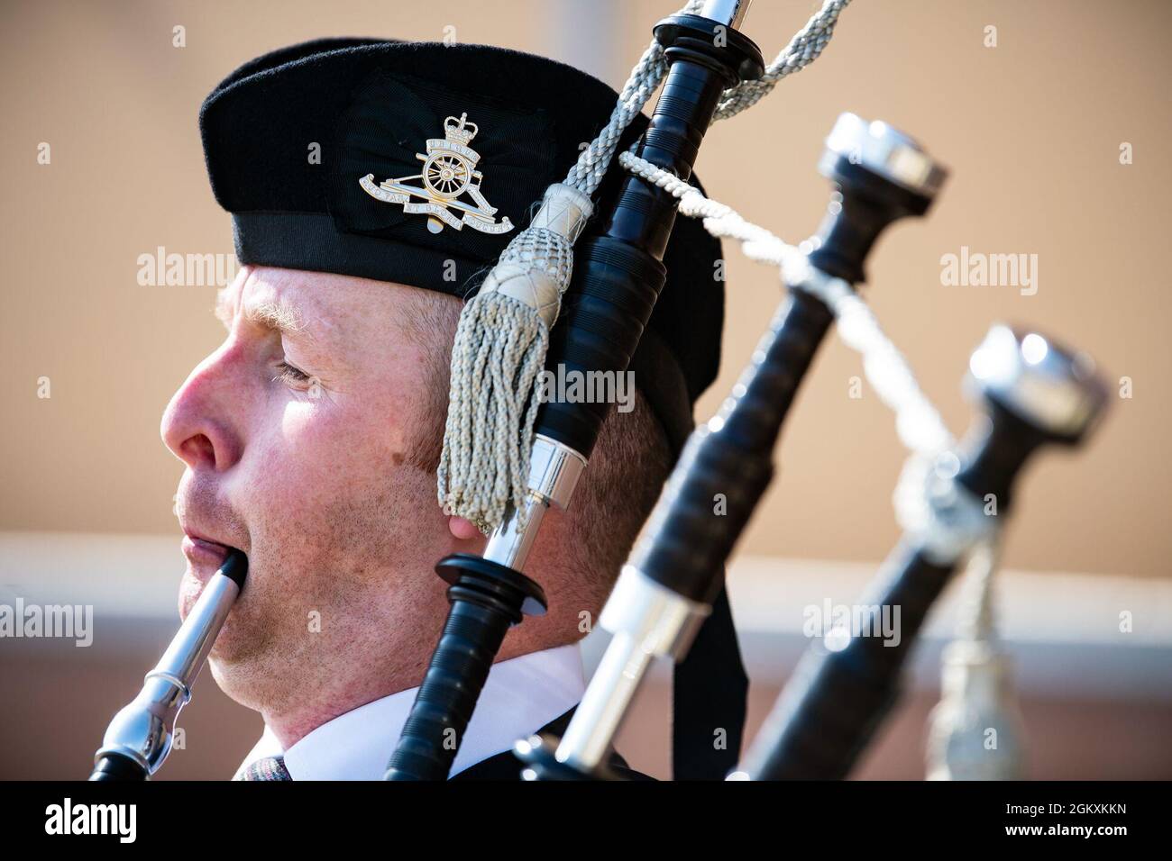 Iain Hildreth, plays the bagpipes prior to a change of command ceremony ...