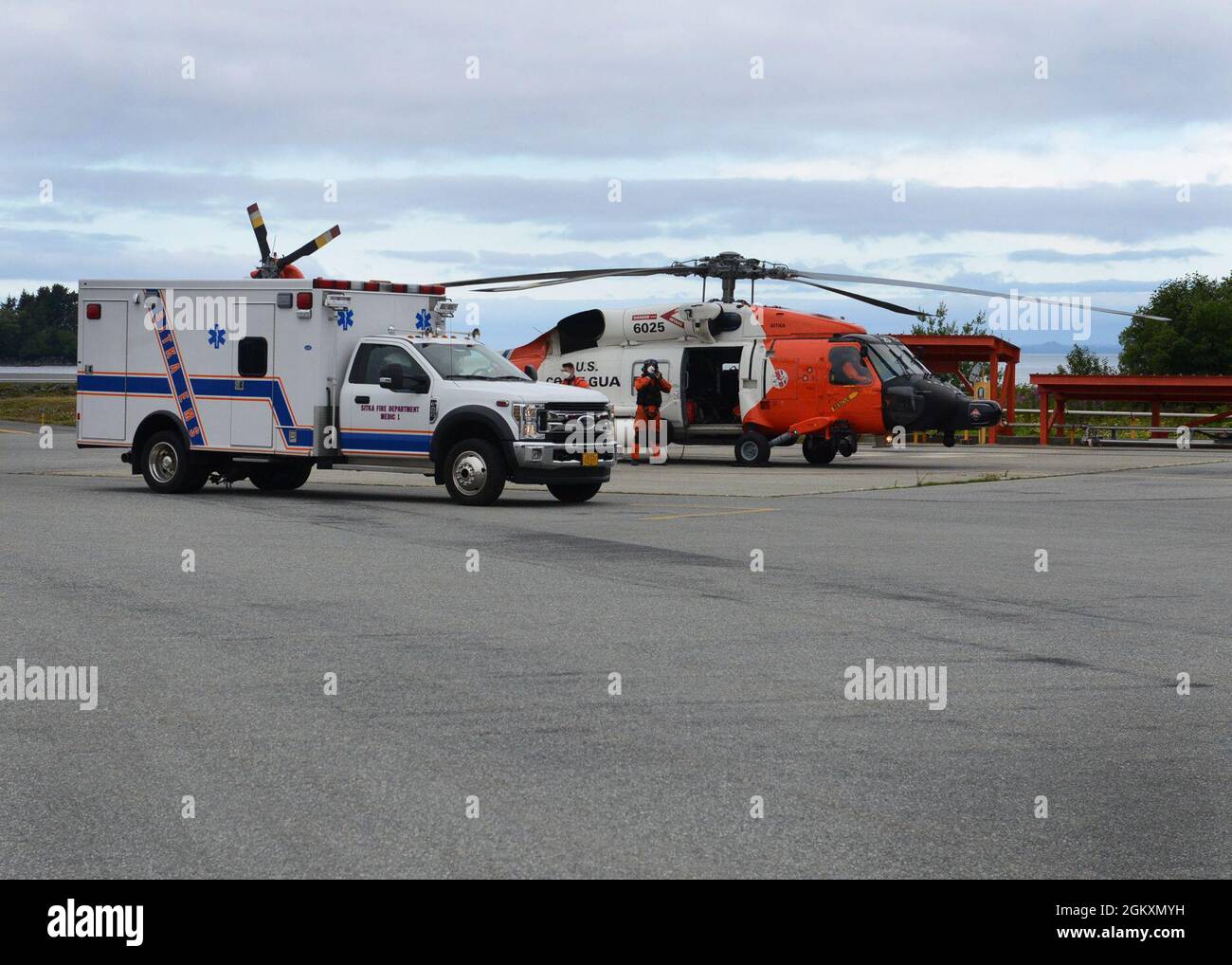 A Coast Guard MH-60 Jayhawk helicopter aircrew preparing to transport a ...