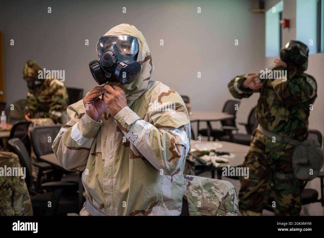 Airmen from the 4th Civil Engineer Squadron don gas masks as a part of ...