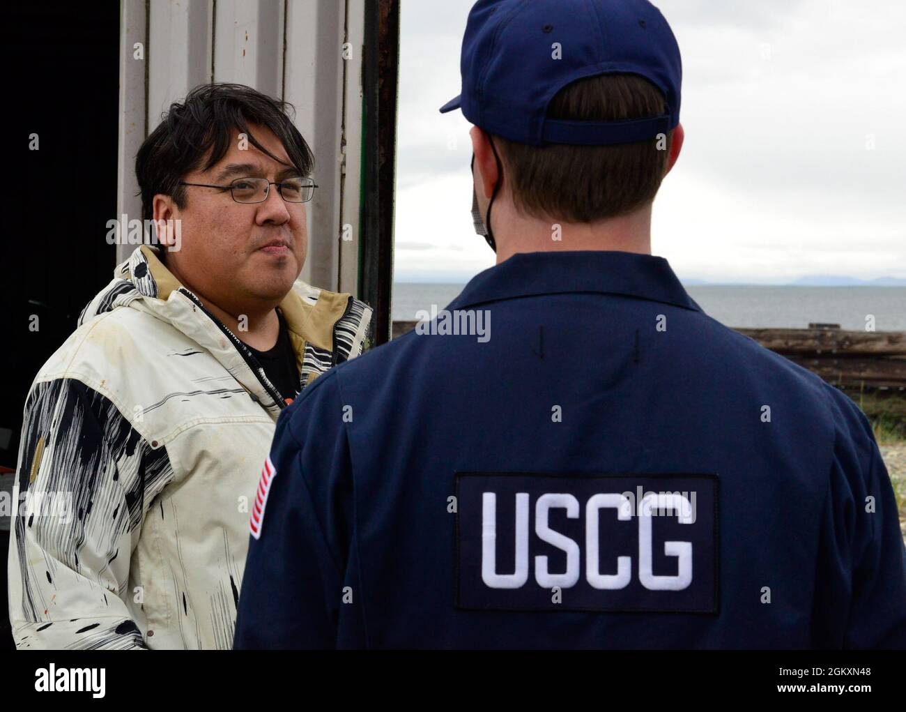 Petty Officer 2nd Class Craig Bennett (right), a marine science ...
