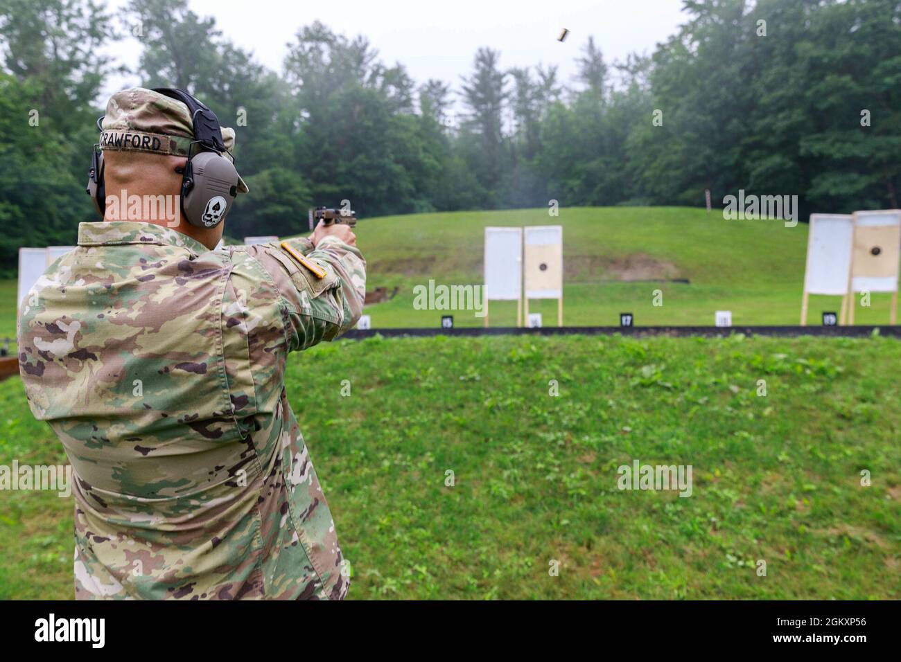 Staff Sgt. Devin Crawford, 108th Training Command, fires an M17 pistol ...