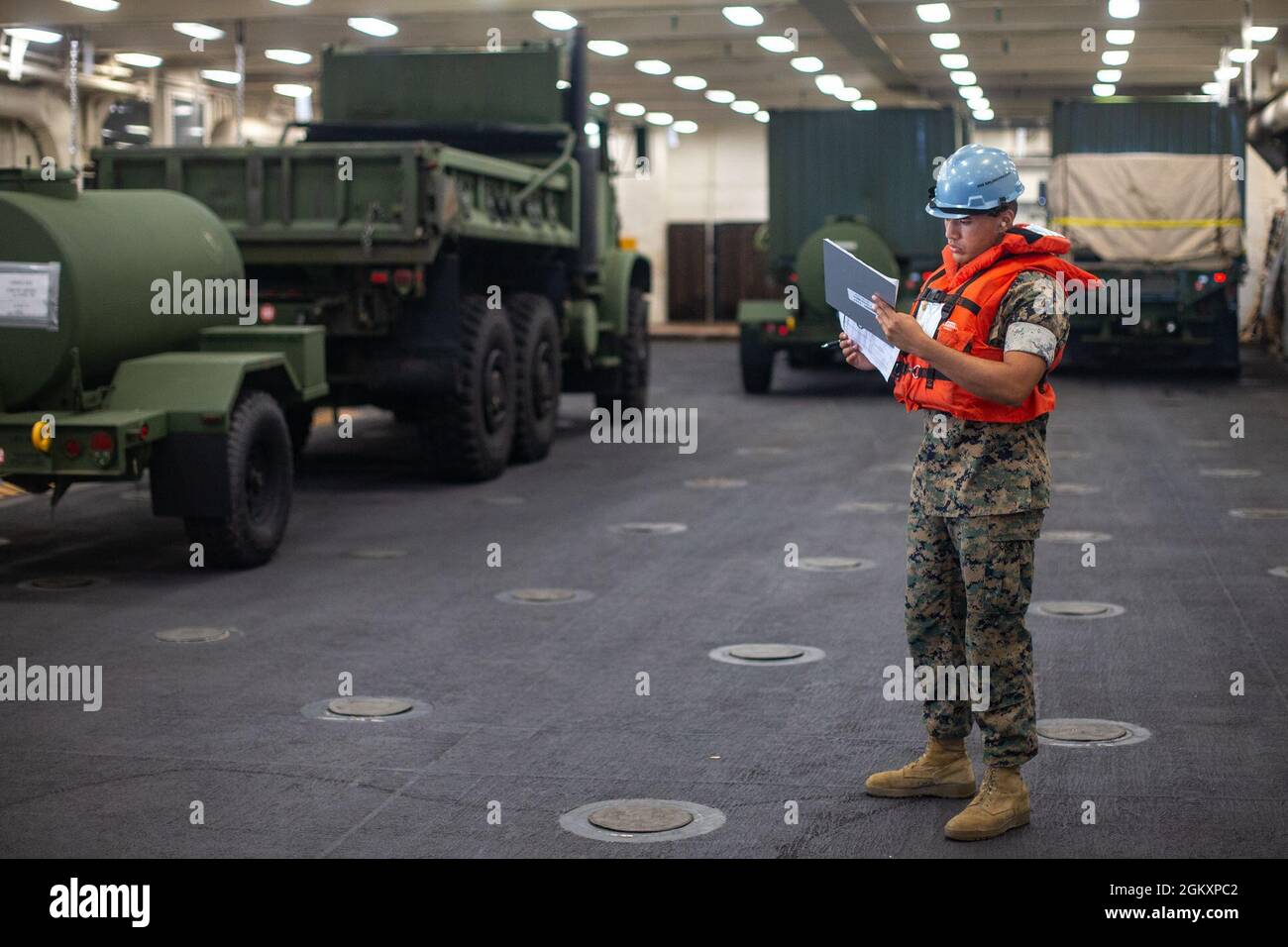 U.S. Marine Corps Lance Cpl. Jonas Cantu checks the vehicle loading ...