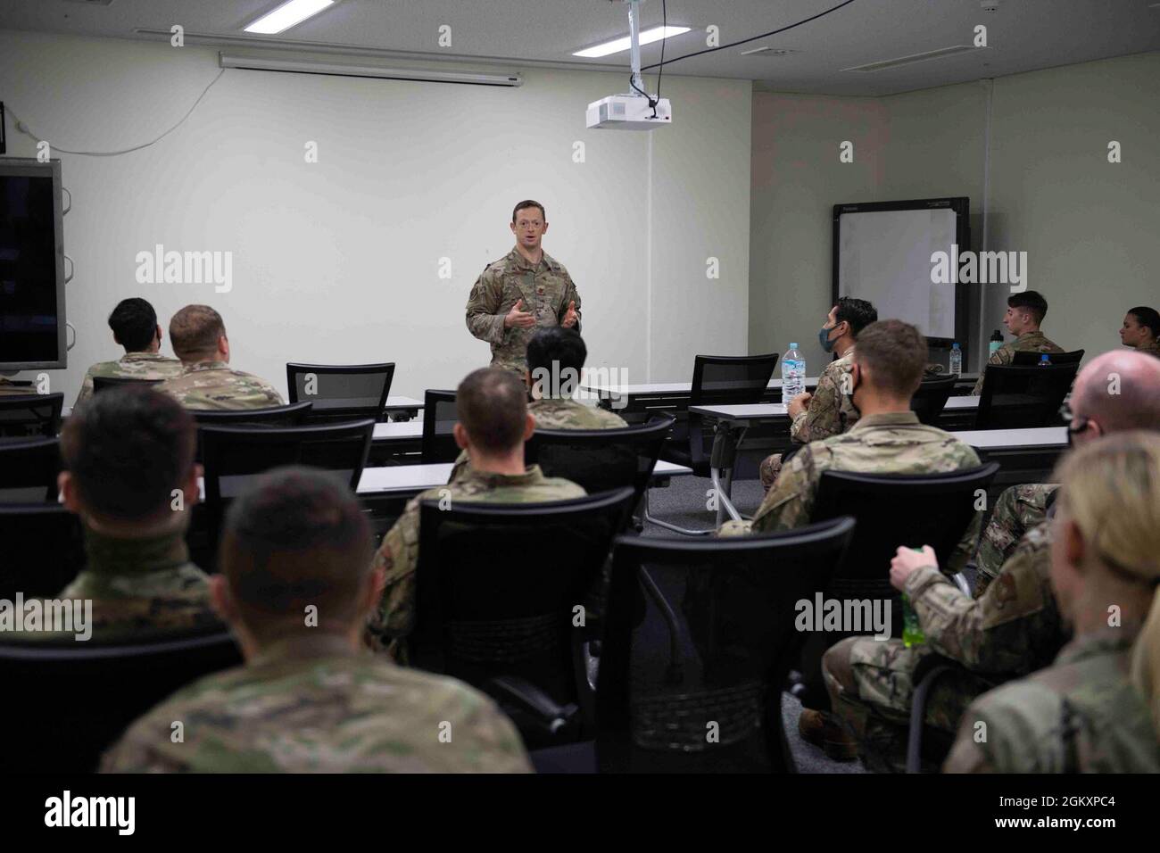 Maj. Matthew Stillman, 374th Security Forces Squadron commander, briefs ...