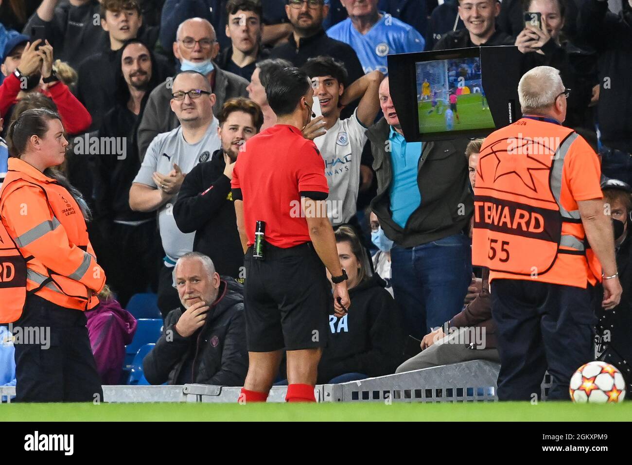 Referee Serdar Gözübüyük checks the VAR pitch side screen to review the ...
