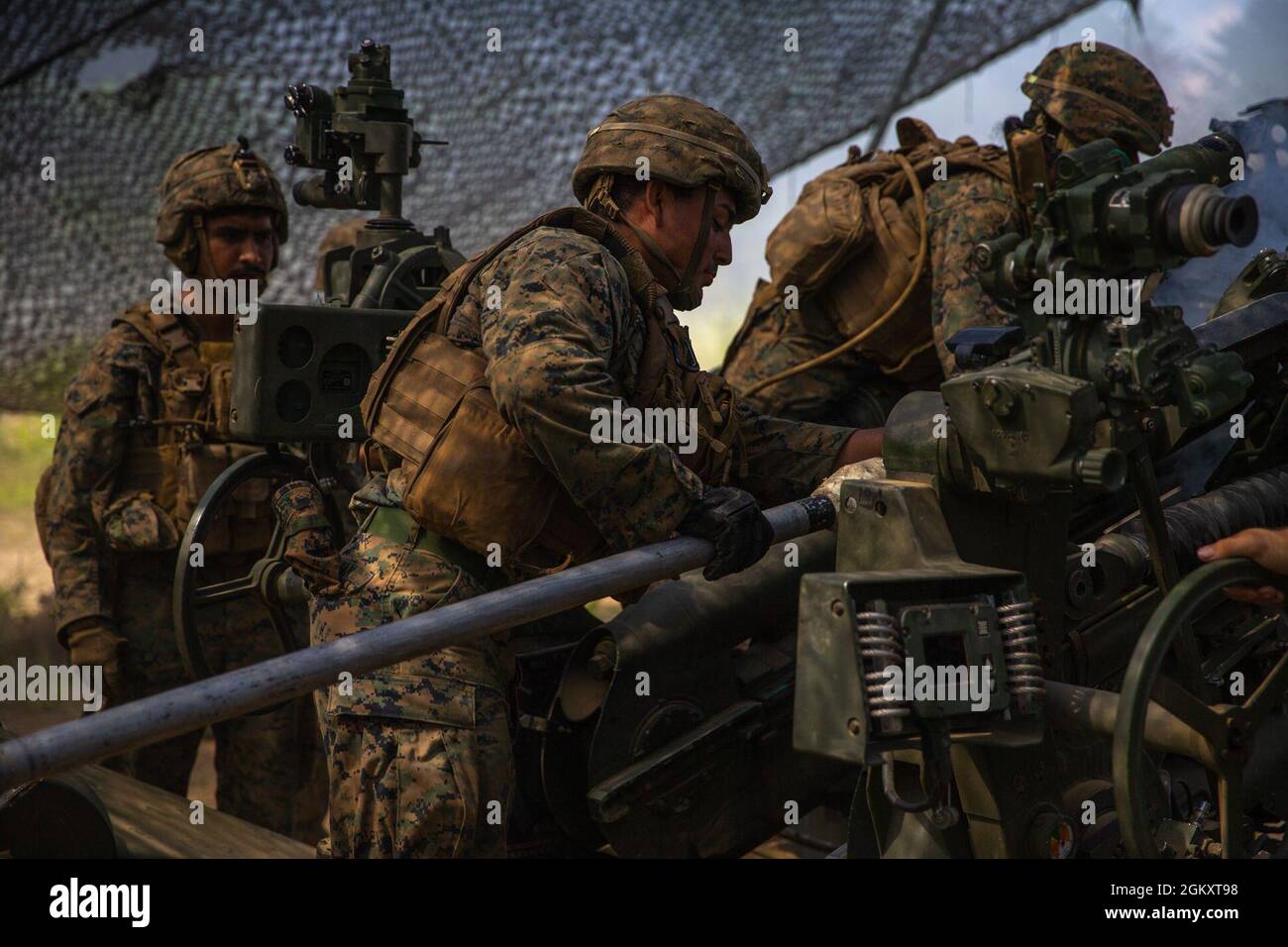 U.S. Marines with 3d Battalion, 12th Marines, 3d Marine Division, load ...