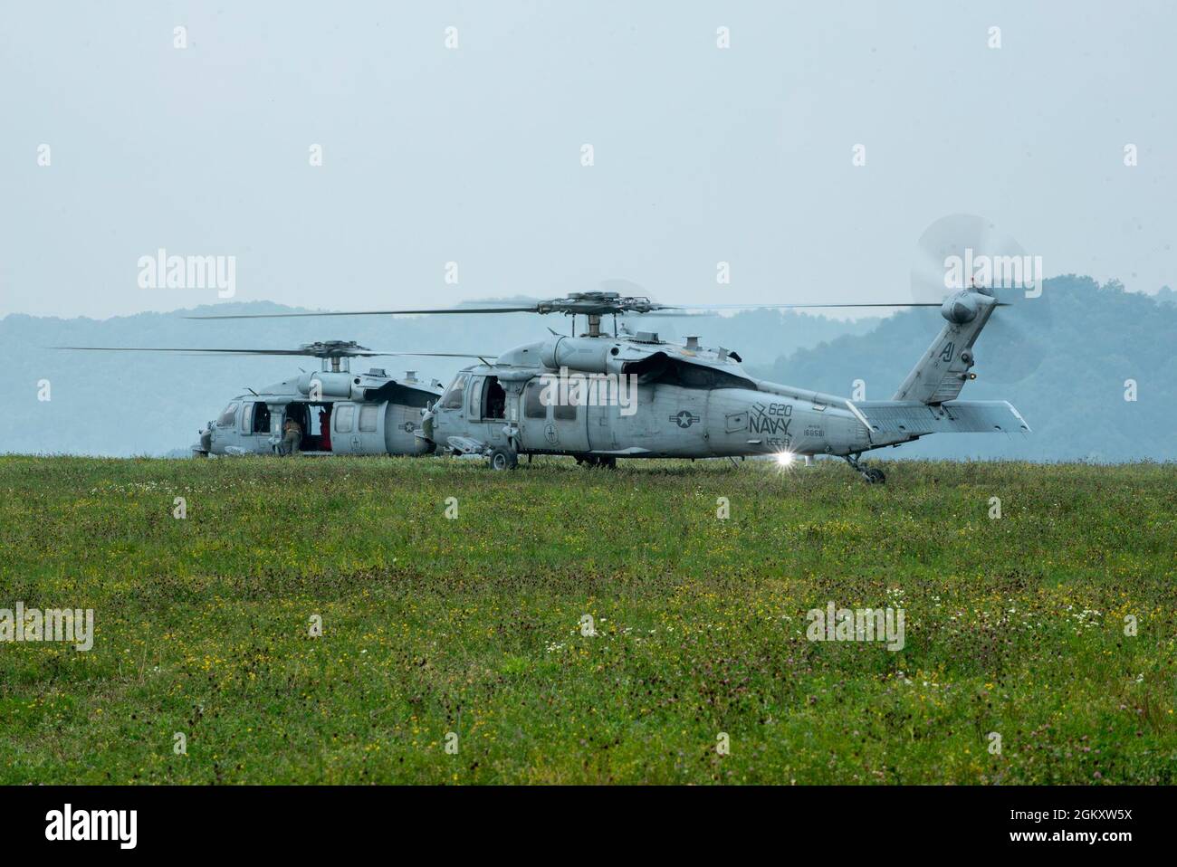 Two MH-60 Seahawk helicopters wait to medically evacuate simulated ...