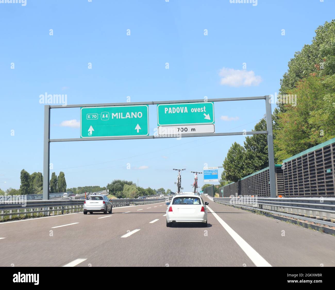 wide Highway sign with the names of the Italian cities of Milan and the ...
