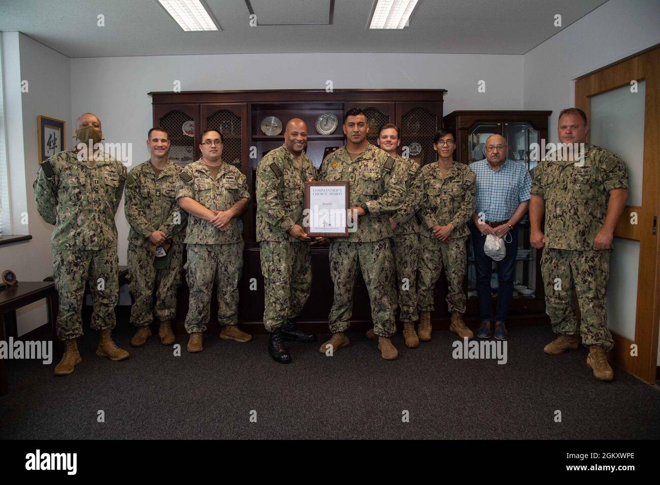 Commander, Fleet Activities Sasebo (CFAS) Capt. David Adams presents ...