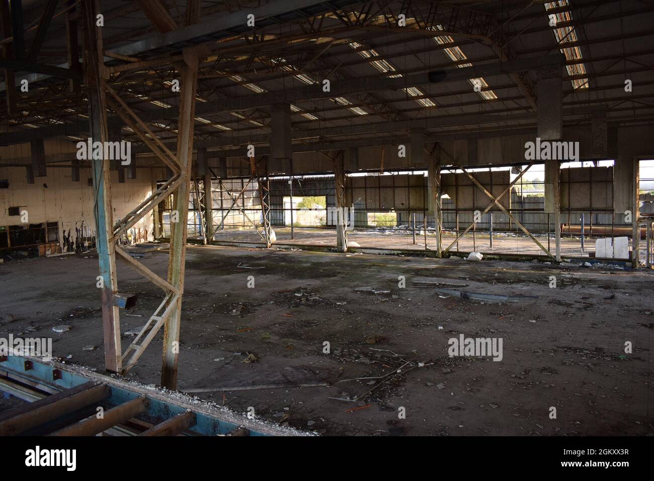 Interior of an old abandoned warehouse with broken windows in the ...