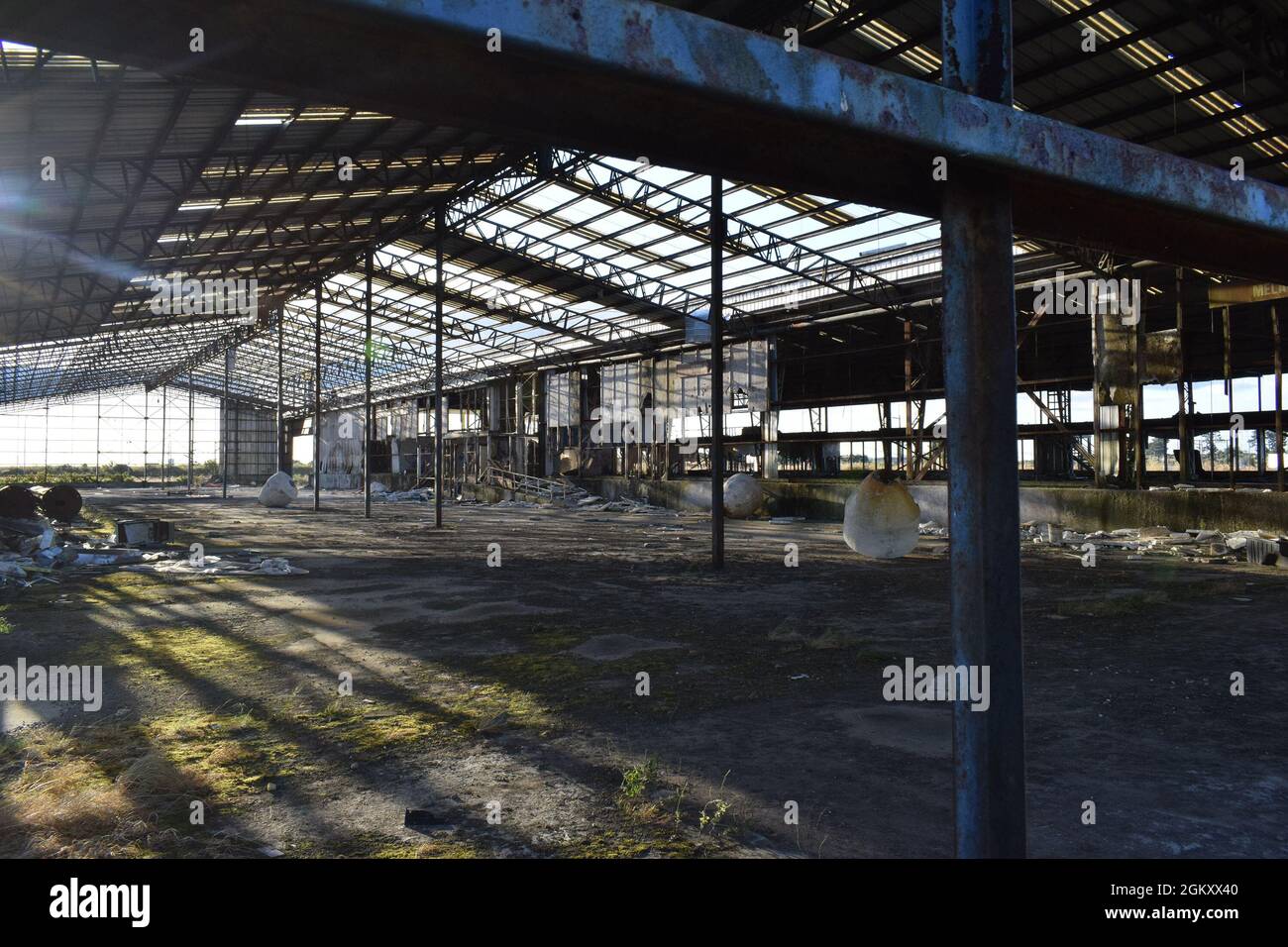 Interior of an old abandoned warehouse with broken windows in the ...