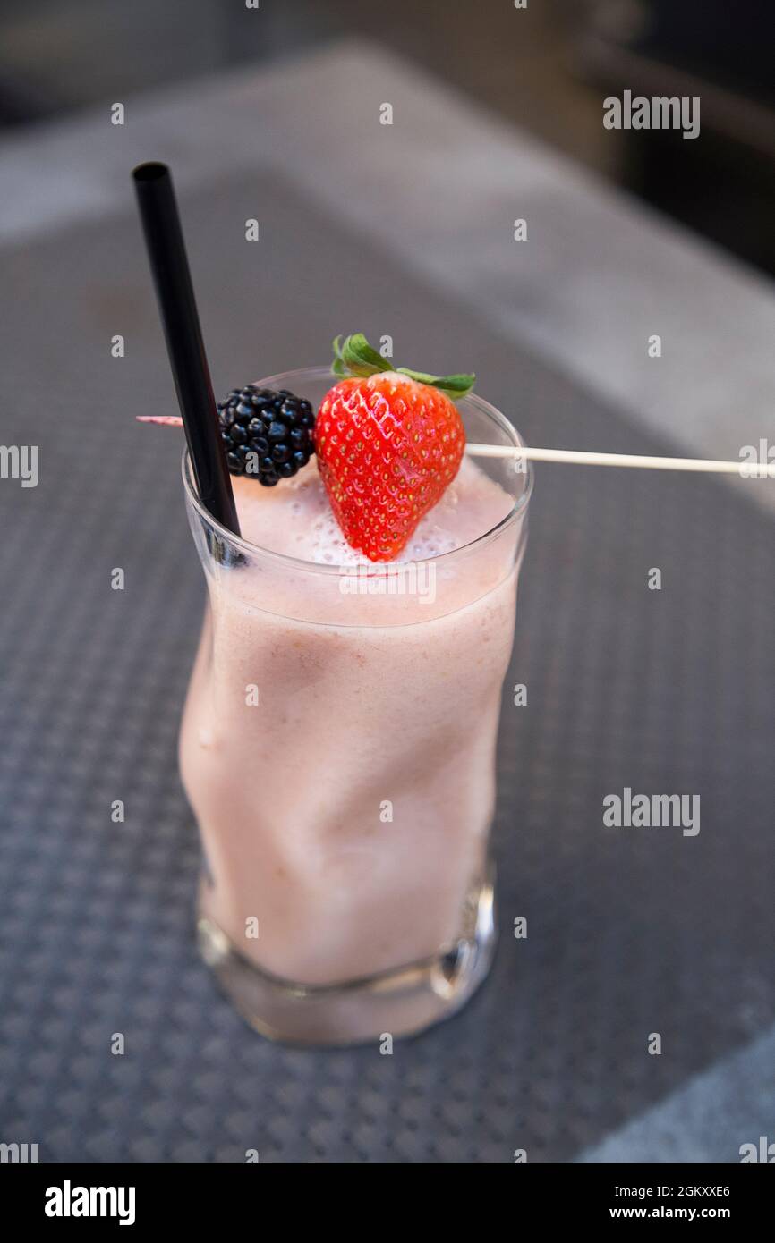 Vertical closeup picture of entire crystal glass of fresh milk shake ...