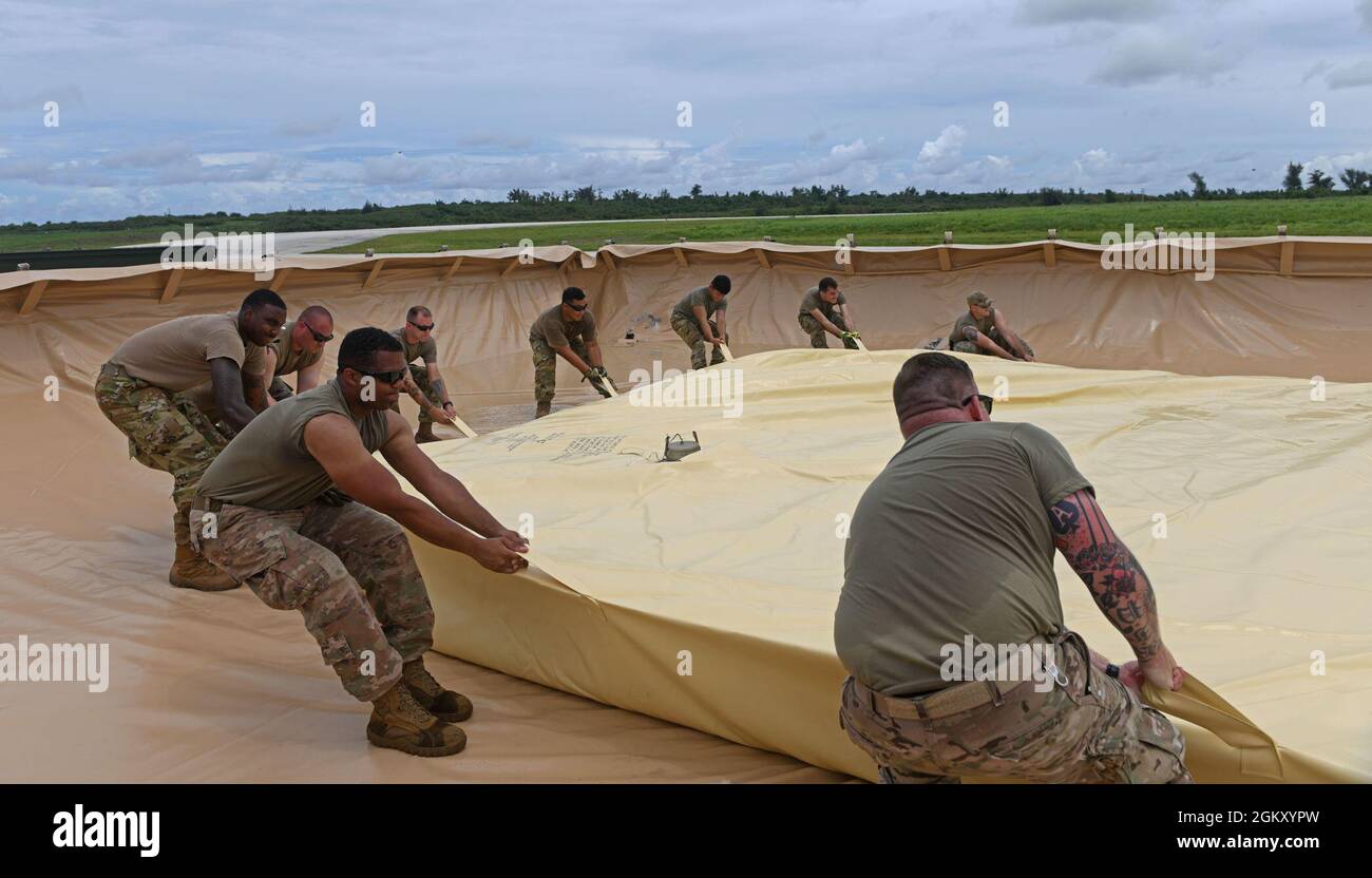 U.S. Air Force Airmen pull on a fuel bladder July 22, 2021, at Tinian ...