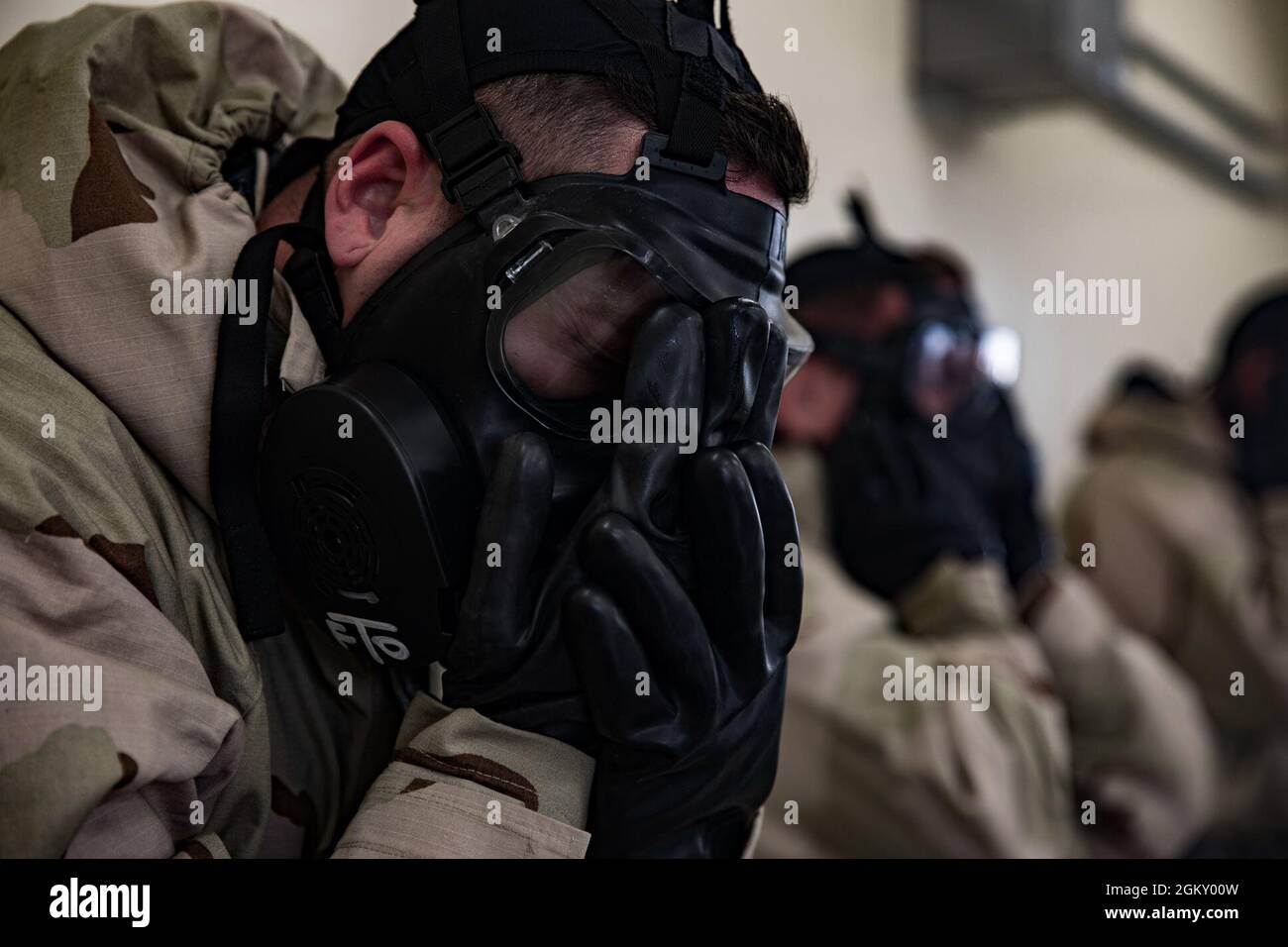 A U.S. Marine with Marine Aircraft Group 12, clears his gas mask at ...