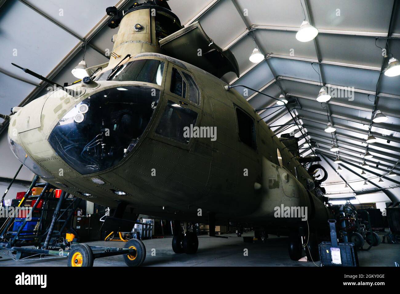 A CH-47 Chinook helicopter sits in a hanger awaiting phase maintenance ...