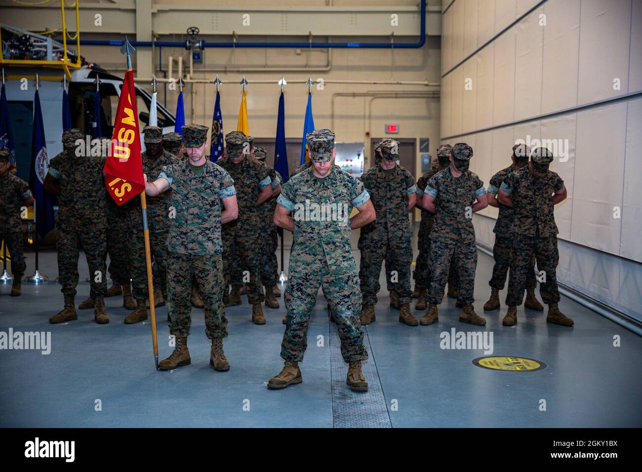 U.S. Marines bow their heads in prayer during the Center for Naval ...