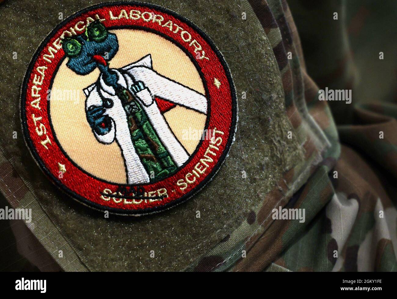 The print on the 1st Area Medical Laboratory's unit patch reads, “Mad ...