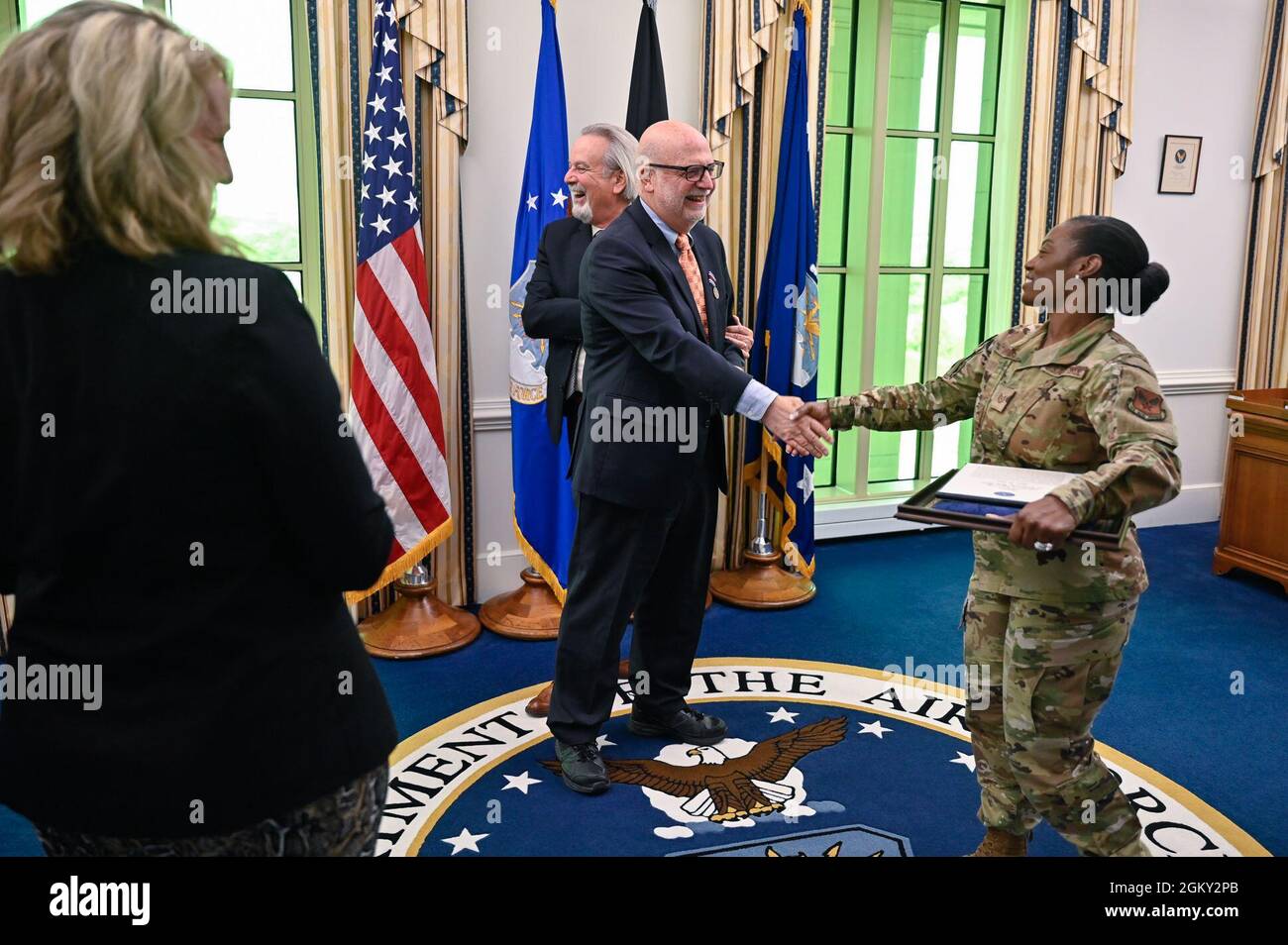 Acting Secretary of the Air Force John P. Roth shakes hands with staff ...
