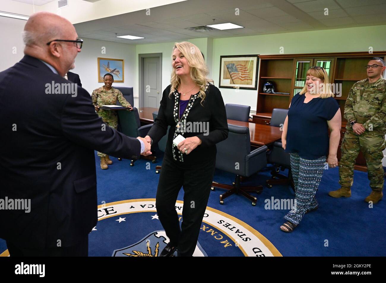 Acting Secretary of the Air Force John P. Roth shakes hands with staff ...