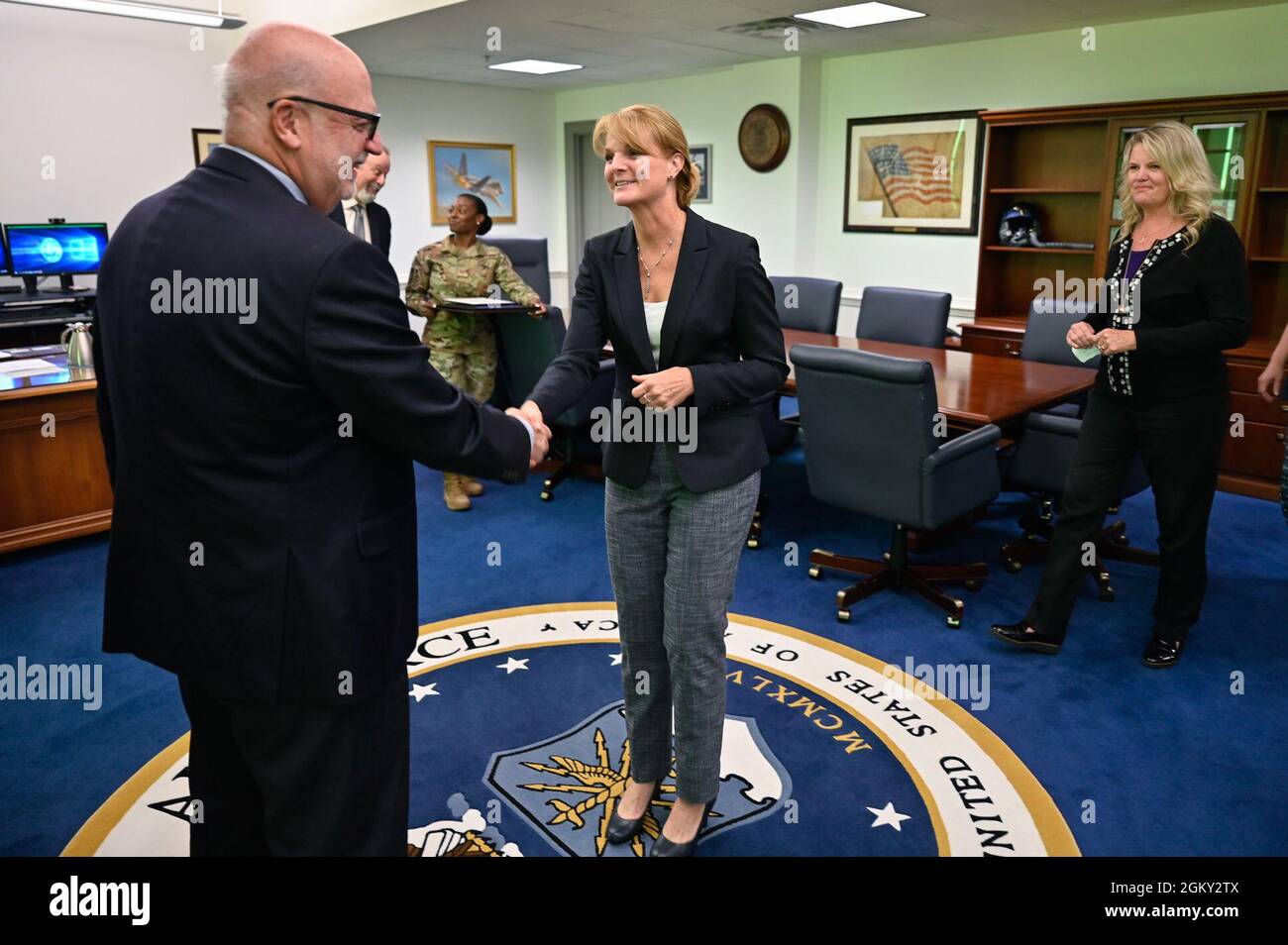Acting Secretary of the Air Force John P. Roth shakes hands with staff ...