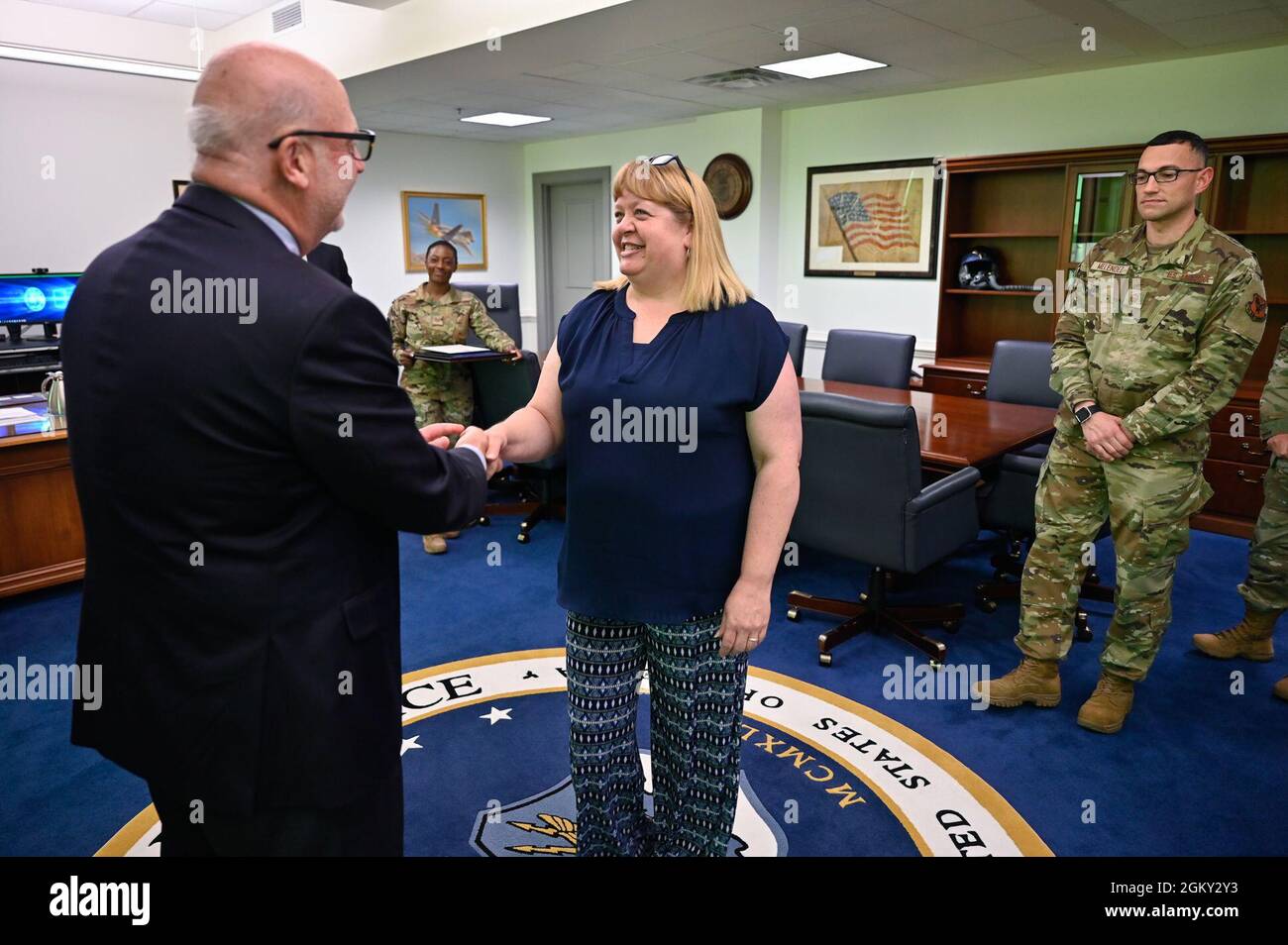 Acting Secretary of the Air Force John P. Roth shakes hands with staff ...