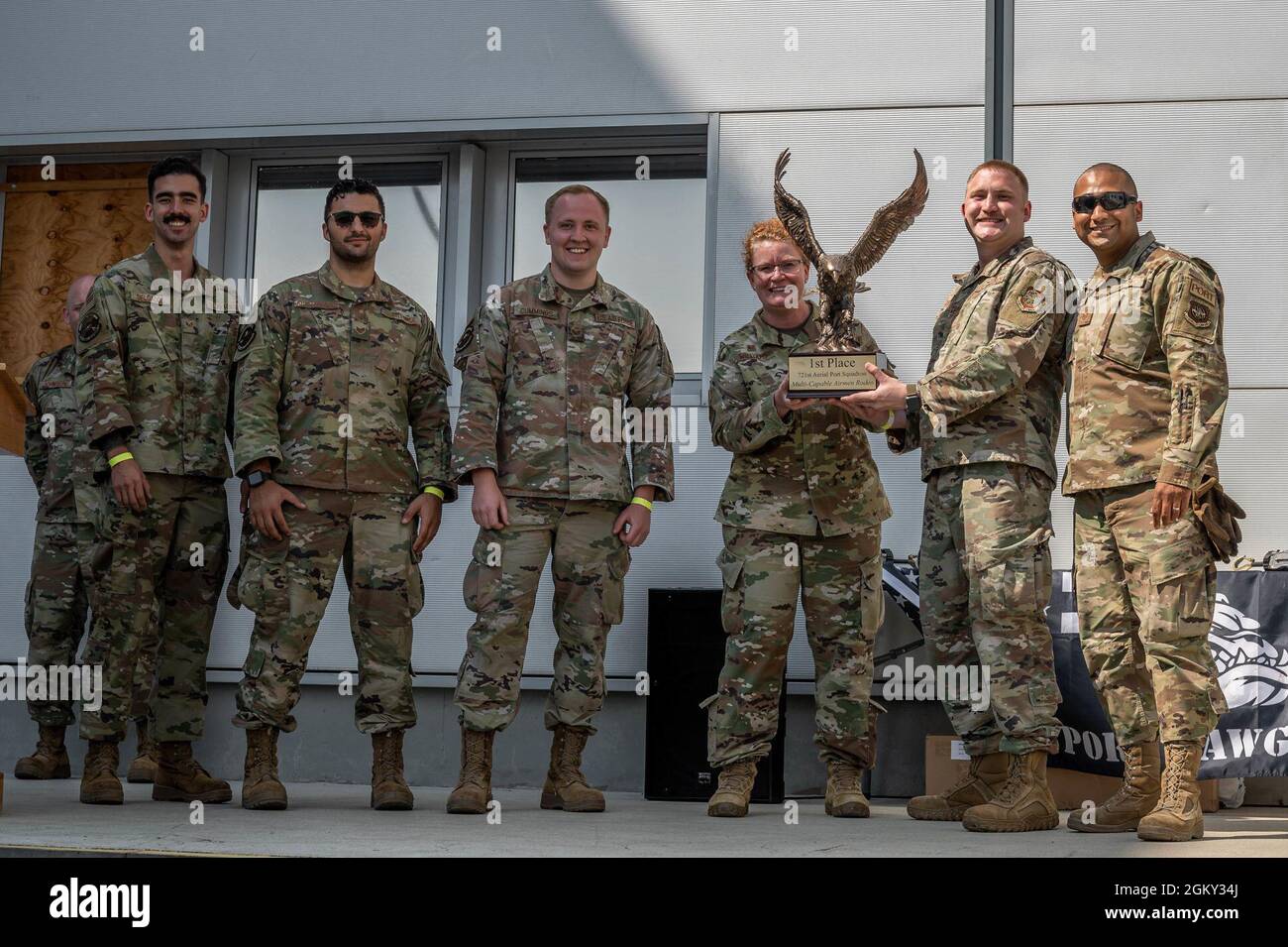 U.S. Air Force Airmen assigned to the 721st Aerial Port Squadron hold their first-place trophy ...