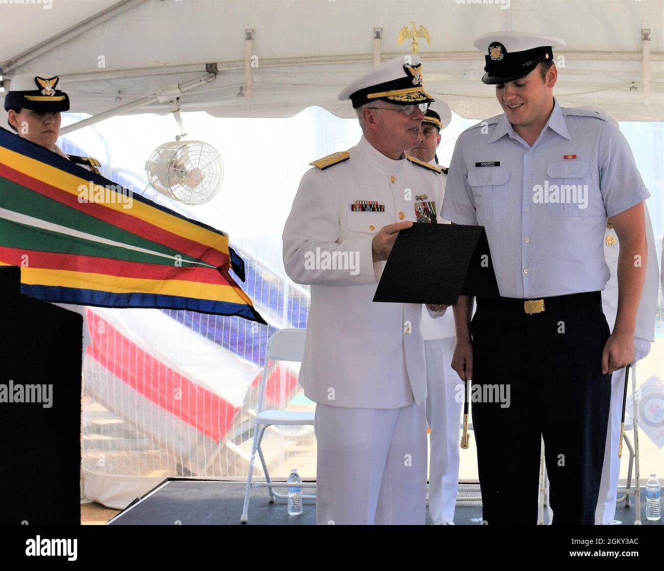 Vice Adm. Steven Poulin presents the unit commendation to Seaman Colin ...