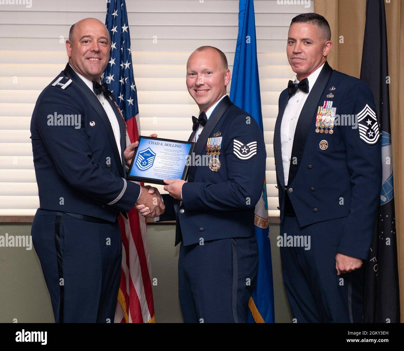 A promotee poses for a photo with Col. Patrick Miller, 88th Air Base ...