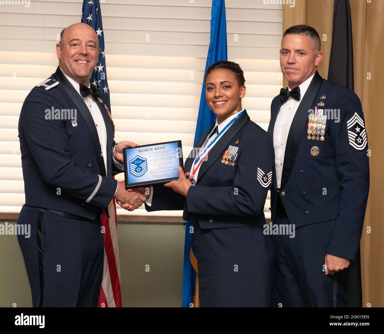 A promotee poses for a photo with Col. Patrick Miller, 88th Air Base ...