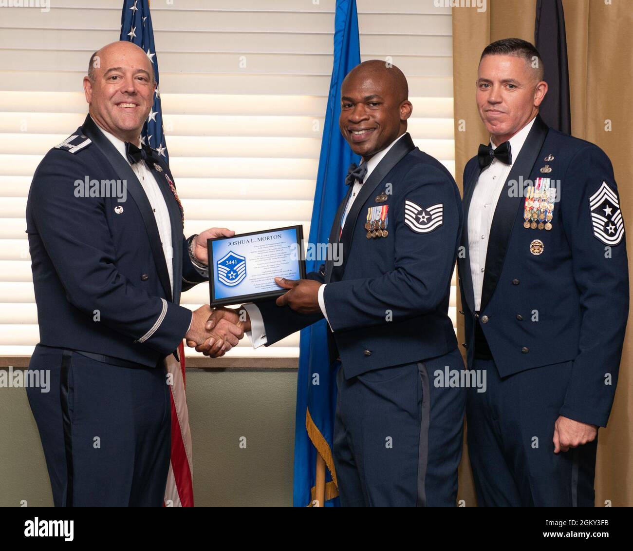 A promotee poses for a photo with Col. Patrick Miller, 88th Air Base ...