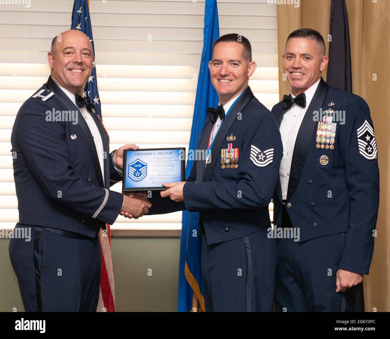 A promotee poses for a photo with Col. Patrick Miller, 88th Air Base ...