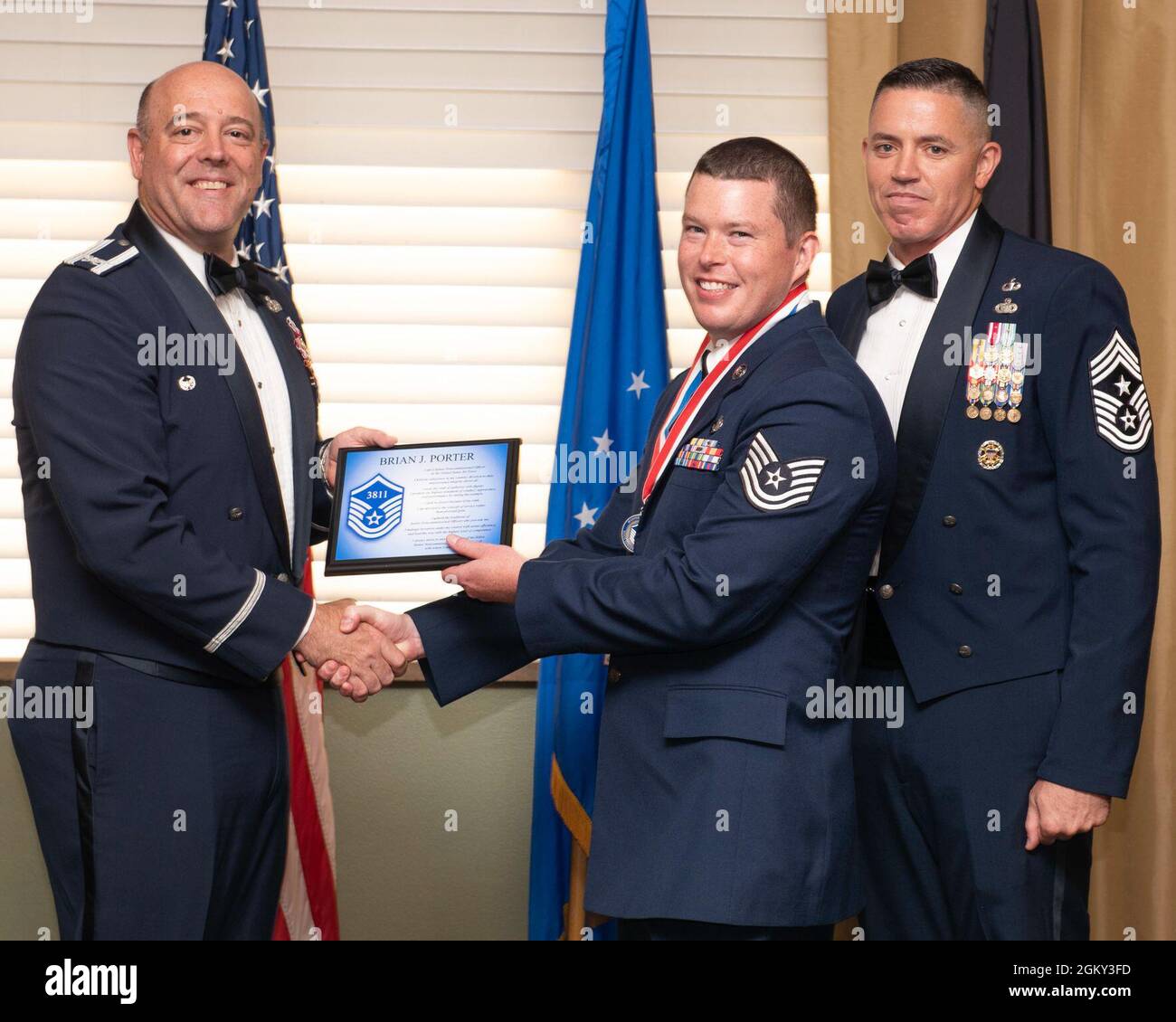 A promotee poses for a photo with Col. Patrick Miller, 88th Air Base ...