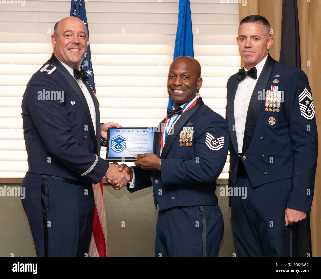 A promotee poses for a photo with Col. Patrick Miller, 88th Air Base ...