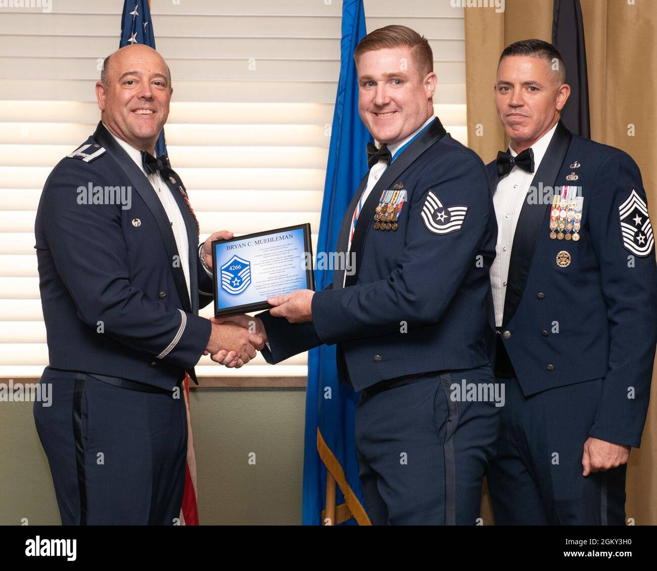 A promotee poses for a photo with Col. Patrick Miller, 88th Air Base ...